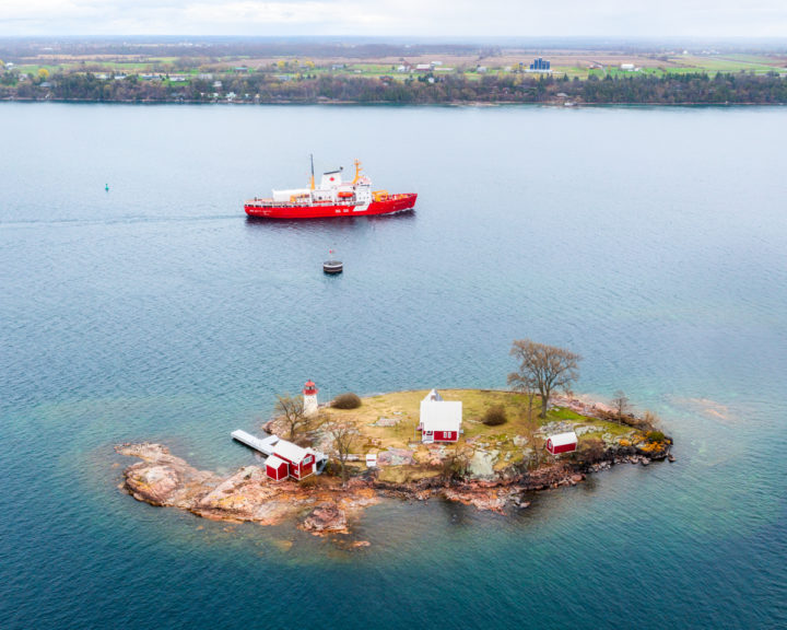 Small Island With Lighthouse and Coast Guard Ship - Duncan.co
